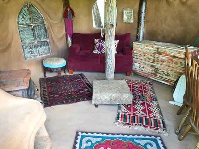 Layered rugs and eclectic seating create a bohemian vibe that Bilbo himself would find delightfully comfortable and inviting.