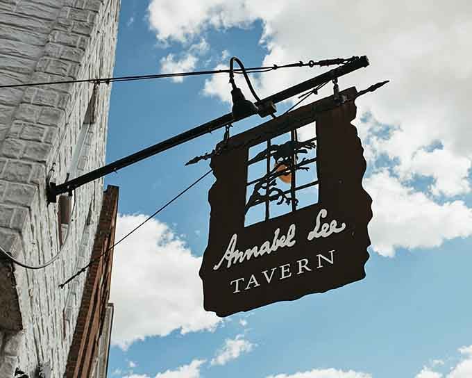 The wrought-iron sign swings overhead, a beacon calling literary lovers and hungry diners to this Gothic gem.