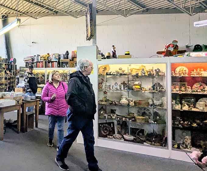 Real shoppers discovering real treasures, because this isn't some sterile showroom but an actual working antique lover's paradise.