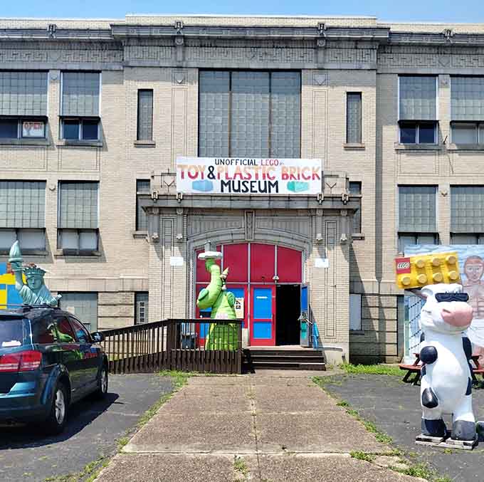 The former fire station exterior welcomes visitors with oversized brick characters that promise adventure inside.