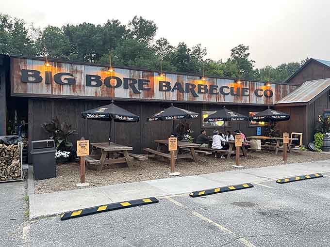 Evening lights illuminate the rustic exterior as outdoor diners enjoy their smoked meats under the Minnesota sky, pure contentment.