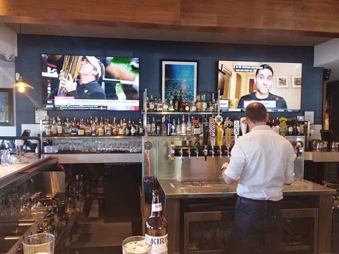 The friendly staff keeping everything running smoothly behind the bar with practiced efficiency and genuine smiles.