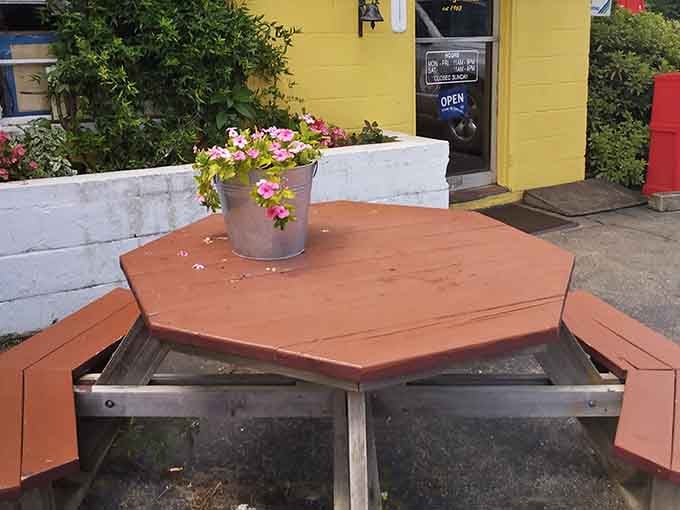 Outdoor seating with flowers adds charm, perfect for enjoying your burger while soaking up some Southern sunshine.