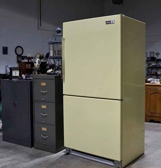 A vintage refrigerator in harvest gold, because avocado green apparently wasn't the only questionable color choice.