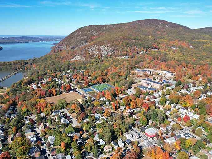 Aerial perspective shows Cold Spring nestled in autumn foliage like a jewel someone carefully placed in nature's crown.