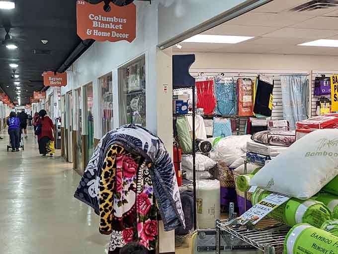 Indoor vendor stalls offering blankets and home d&eacute;cor, because comfort shopping should actually lead to comfortable homes.