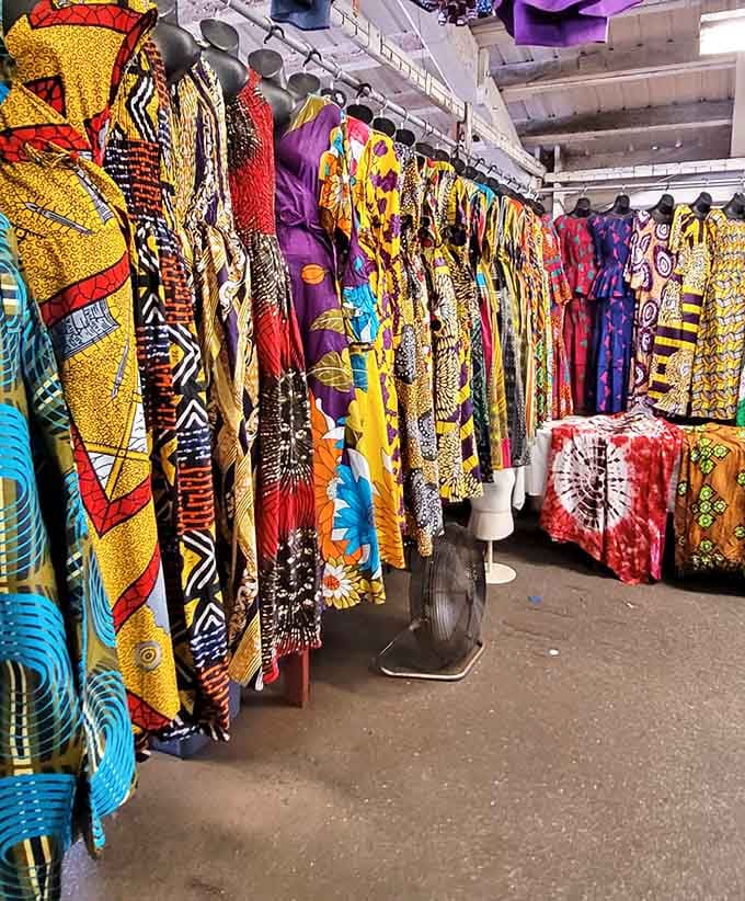 African print fabrics hanging in brilliant patterns that make every other garment rack look tragically boring by comparison.
