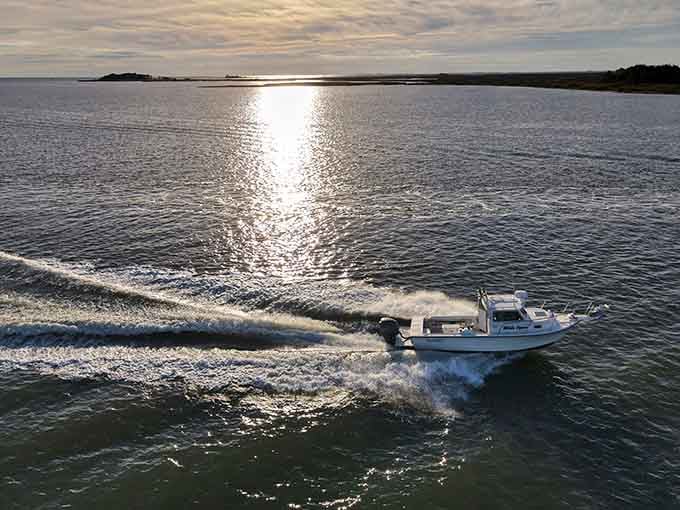 A workboat heading home as the sun sets, the daily rhythm that's defined Crisfield for more generations than anyone's counting.
