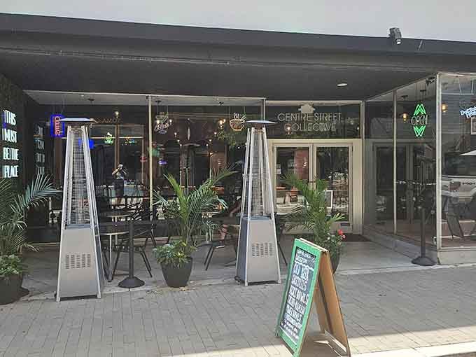 Modern patio heaters and potted plants create an urban oasis where coffee tastes better and conversations linger longer.