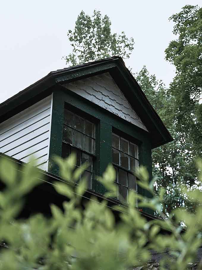 Green trim against white siding, because even ghost towns deserve a little color coordination in their twilight years.