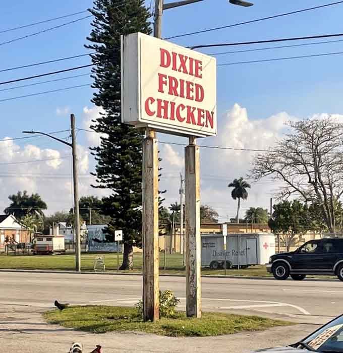 That bold red lettering against white background doesn't whisper, it announces fried chicken excellence to everyone passing by Belle Glade.