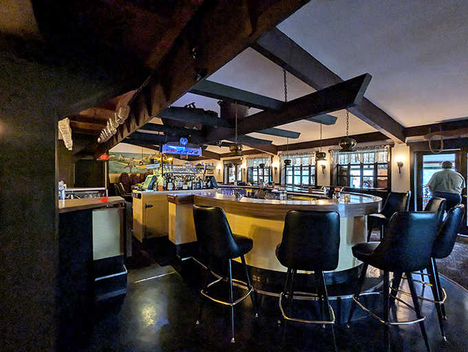 The curved bar with comfortable seating invites you to settle in for a proper Old Fashioned or three.