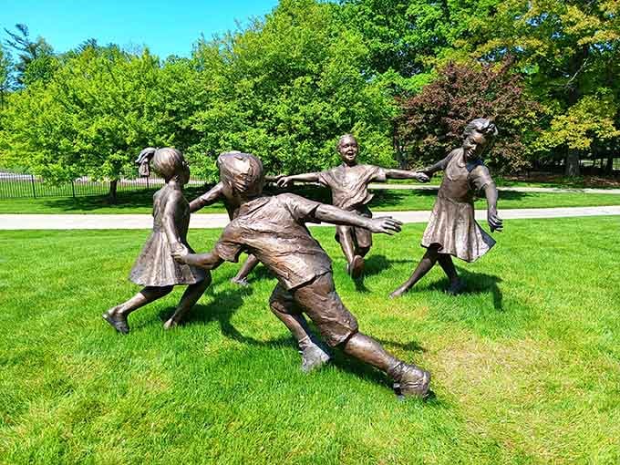 Bronze sculptures of children playing capture pure joy frozen in time on the perfectly manicured lawn.