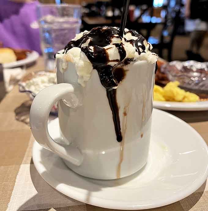 Hot chocolate piled so high with whipped cream it's practically a structural engineering marvel worth photographing.
