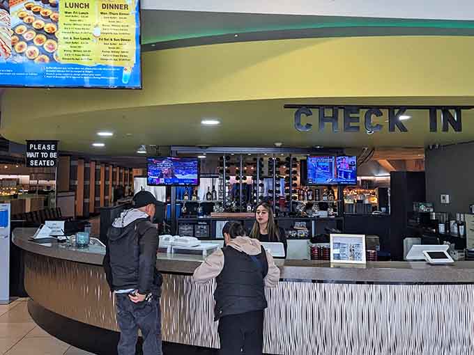 The check-in area welcomes you warmly, where friendly faces prepare you for the delicious journey ahead inside.