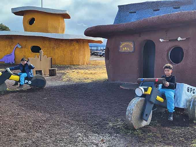 Young visitors patrol Bedrock on official police cycles, living out their cartoon fantasies in three-dimensional reality.