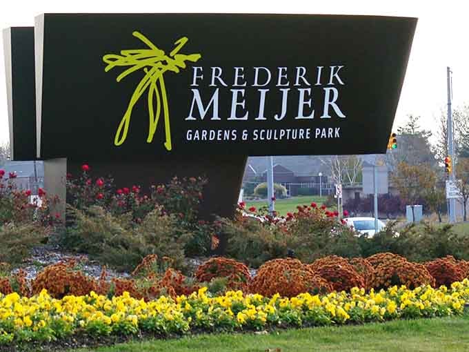 Cheerful seasonal blooms frame the entrance sign, announcing your arrival at this remarkable fusion of horticulture and art.