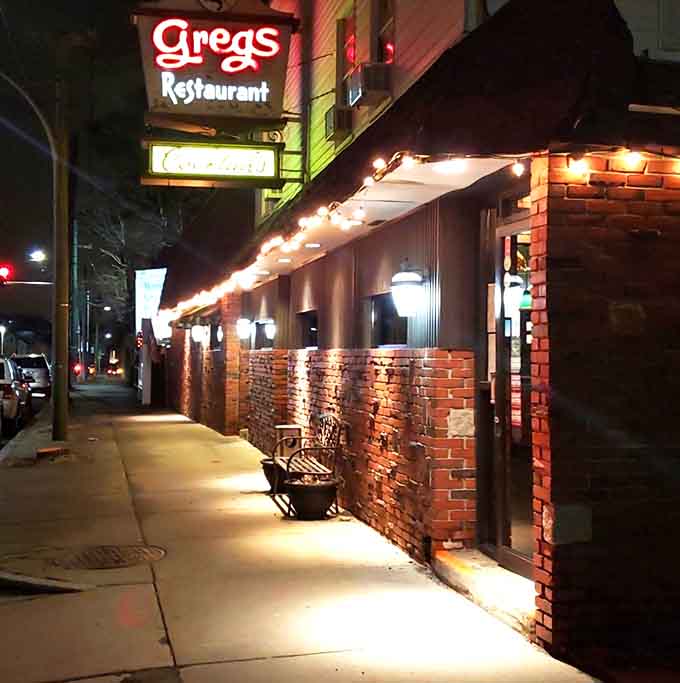 The welcoming entrance at night promises warmth, good food, and the kind of meal you'll be thinking about tomorrow.