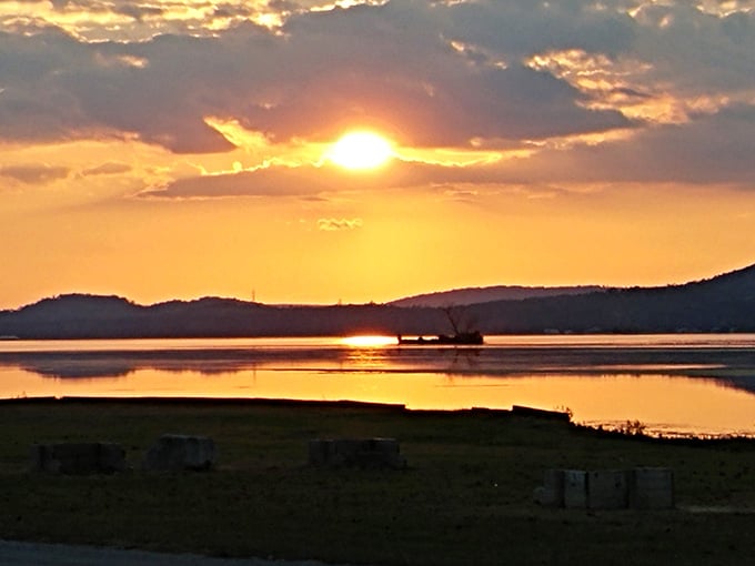 Sunset over Lake Guntersville paints the sky in colors that no camera quite captures, but you'll try anyway because wow.