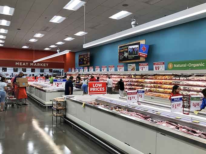 The meat market section stretches on like a carnivore's fever dream, beautifully lit and ready for your dinner plans.