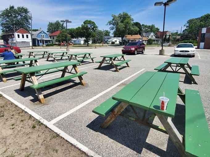 Green picnic tables waiting for sunny days and messy burgers, the outdoor dining experience Michigan summers were made for.