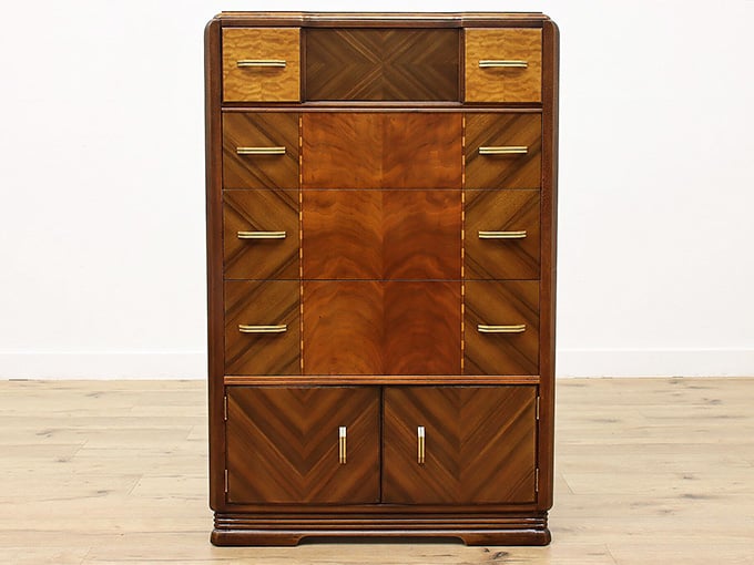 Clean lines, rich wood grain, and gold hardware make this Art Deco dresser an absolute showstopper.