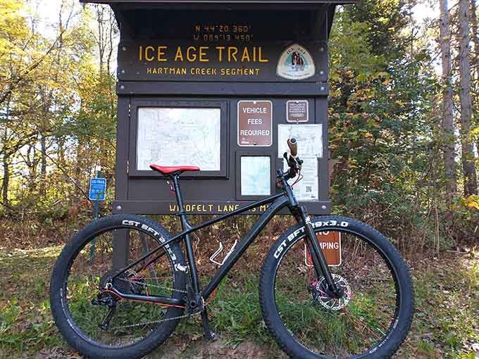 The Ice Age Trail trailhead, where your mountain bike adventure begins with proper signage and endless possibilities.