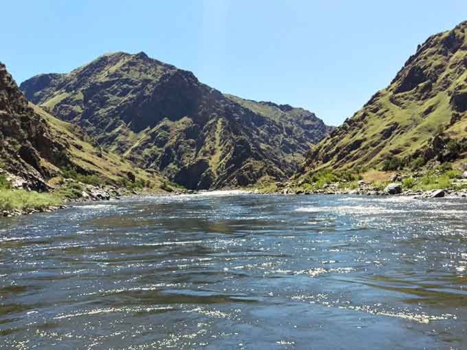 Sunshine illuminating North America's deepest river gorge, making Arizona's famous hole look downright shallow by comparison.