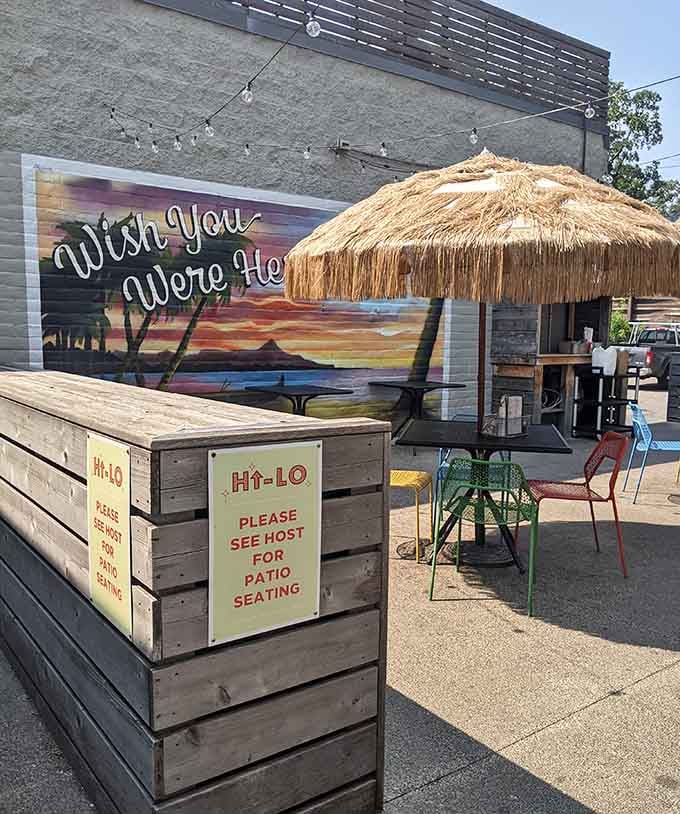 Outdoor patio seating with a tiki umbrella proves that diners can have tropical vacation vibes too.