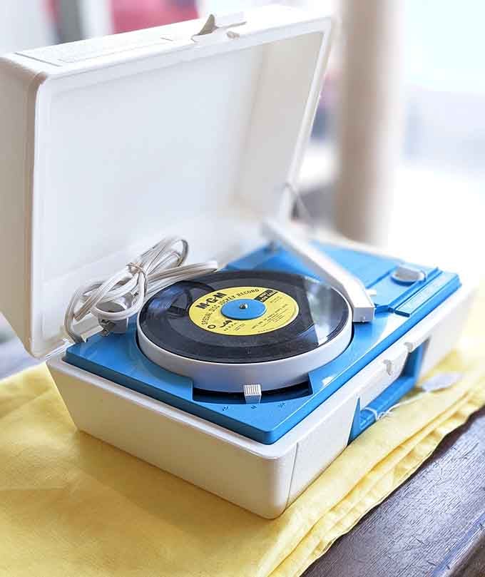 A portable record player ready to spin some vinyl and transport you straight back in time.