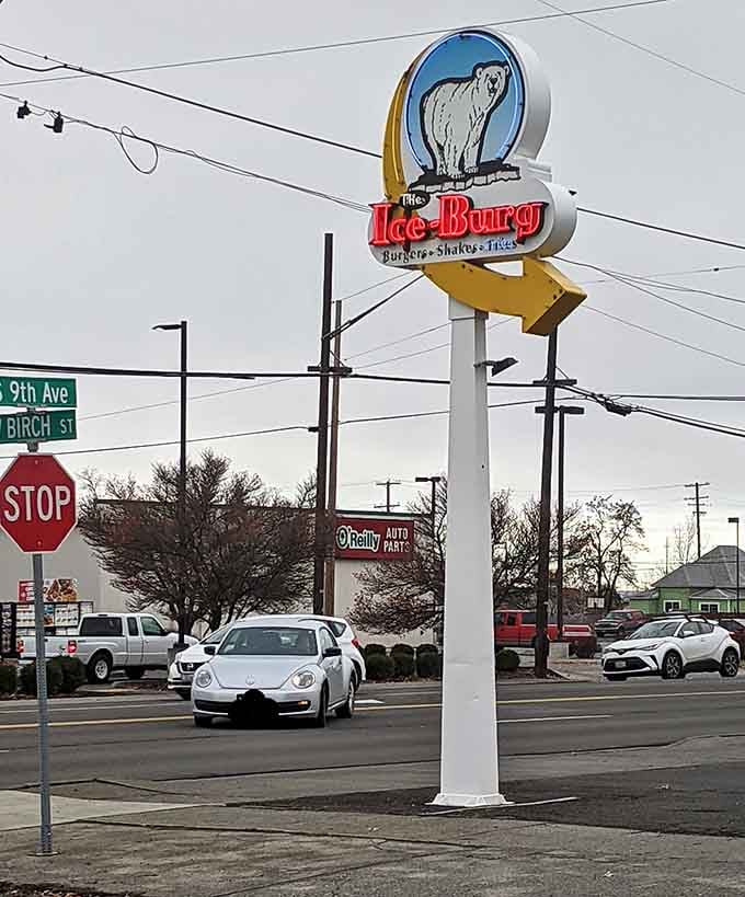 That vintage roadside sign stands tall like a delicious landmark, guiding the hungry home to burger paradise below.