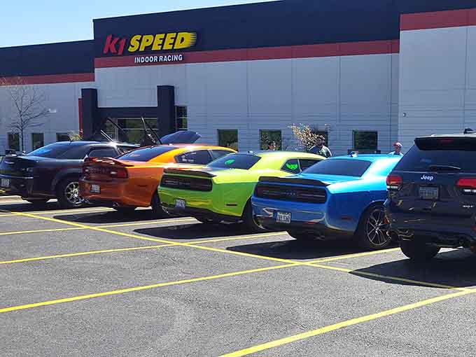 The exterior where colorful muscle cars gather, probably comparing notes on who's faster inside versus outside today.
