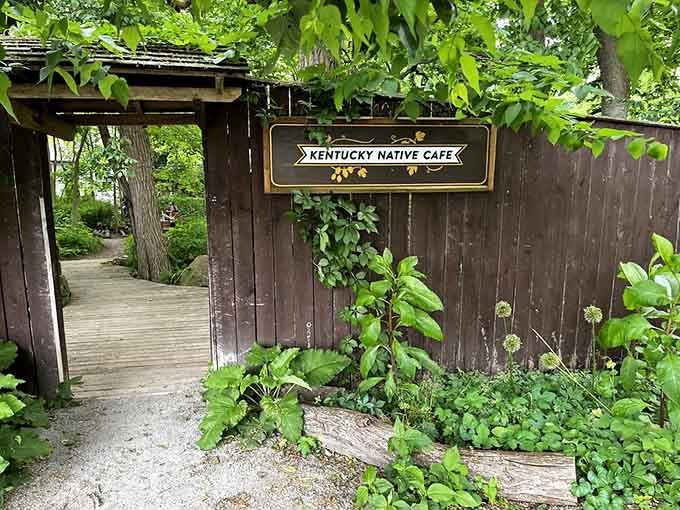 This garden entrance with its hand-painted sign promises something special, and spoiler alert: it absolutely delivers on that promise.