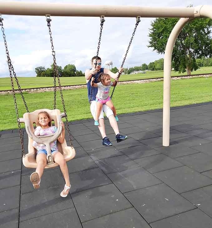 Dad on the swings alongside his daughter. King Jack Park has a way of bringing out the kid in everyone.