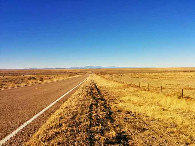 Open roads stretch toward horizons so big they make your problems feel appropriately small and manageable.