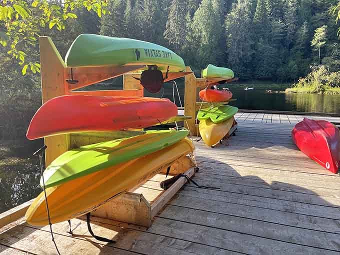 Colorful kayaks stacked and ready remind you that the best adventures require nothing but a paddle.