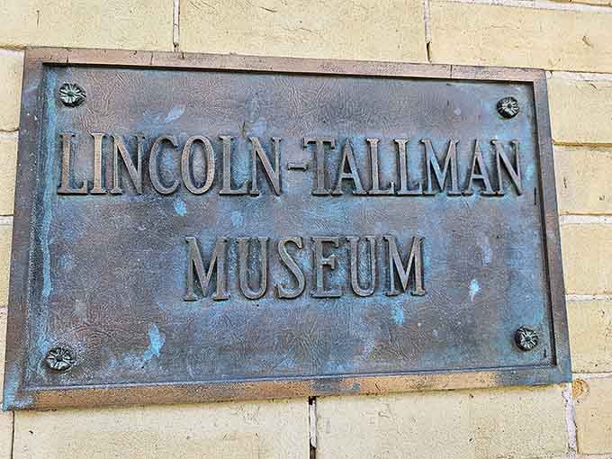 This weathered bronze plaque marks your gateway to authentic history, not some theme park version with gift shops everywhere.