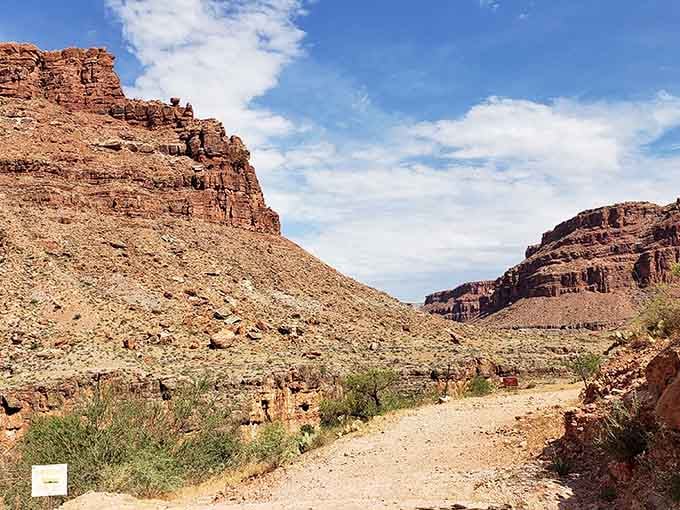 This dusty trail through towering canyon walls is your gateway to one of Arizona's most spectacular hidden treasures.