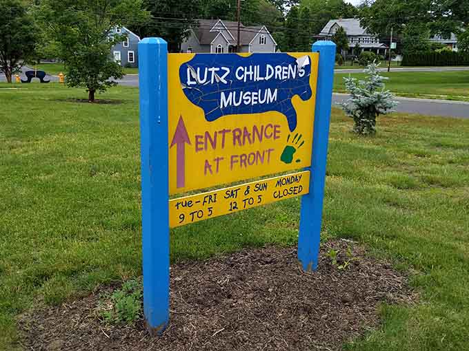 The hand-painted sign points you toward childhood magic, open Tuesday through Sunday for family adventures.
