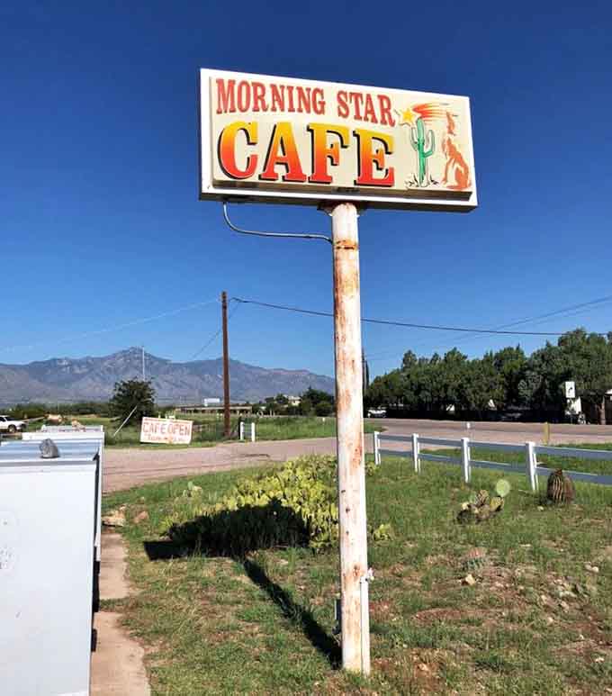The roadside sign standing proud against Arizona sky, beckoning hungry travelers to pull over and stay awhile.