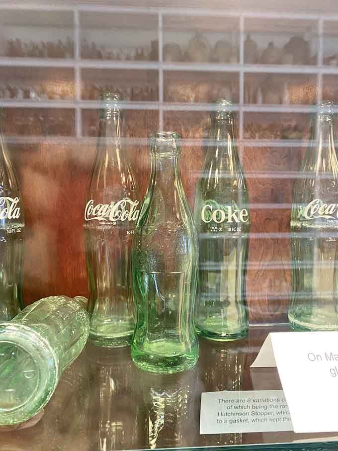 Classic Coca-Cola bottles trace the evolution of America's most iconic beverage container through decades of design changes.