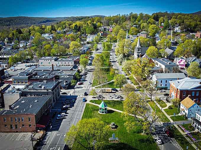 An aerial view reveals New Milford's perfect town layout, like someone actually planned this place with care.