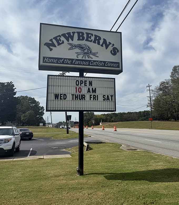 The road sign announces operating hours like a beacon guiding the hungry faithful home to their favorite meal.