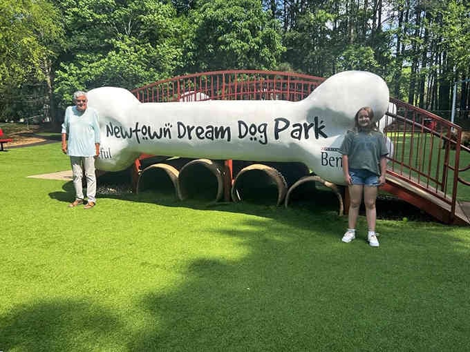 The giant bone sculpture serves as both landmark and photo op for proud dog parents documenting their adventures.