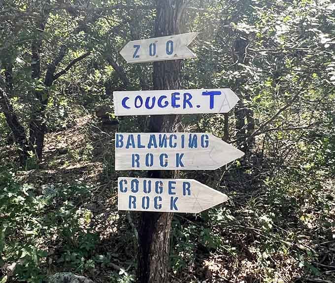 Hand-painted directional signs pointing to "Cougar Rock" and "Balancing Rock"&mdash;charmingly low-tech navigation at its finest.