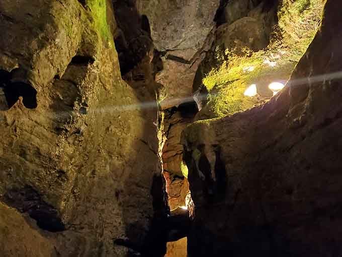 Massive rock formations dwarf human visitors, a humbling reminder of nature's scale and patient artistry.