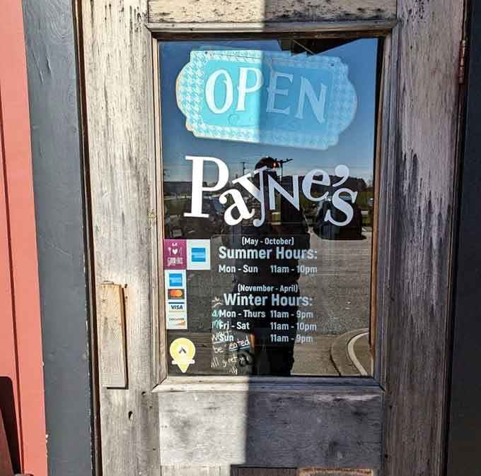 Business hours posted on the door help you plan your British culinary adventure around seasonal schedules.