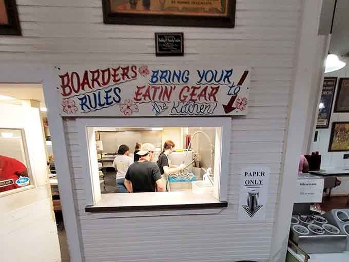 The kitchen pass-through window offers a glimpse into where the magic happens, where ordinary chicken becomes extraordinary.