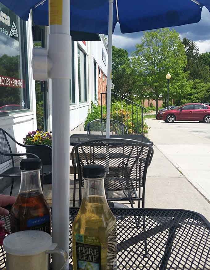Outdoor seating on a sunny day with cold drinks, where Main Street becomes your personal dining room with a view.