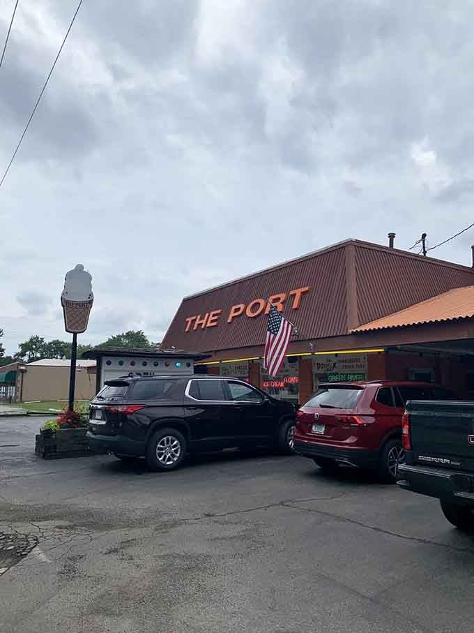 Cars lined up at a drive-in on a cloudy day, because good food doesn't require perfect weather.